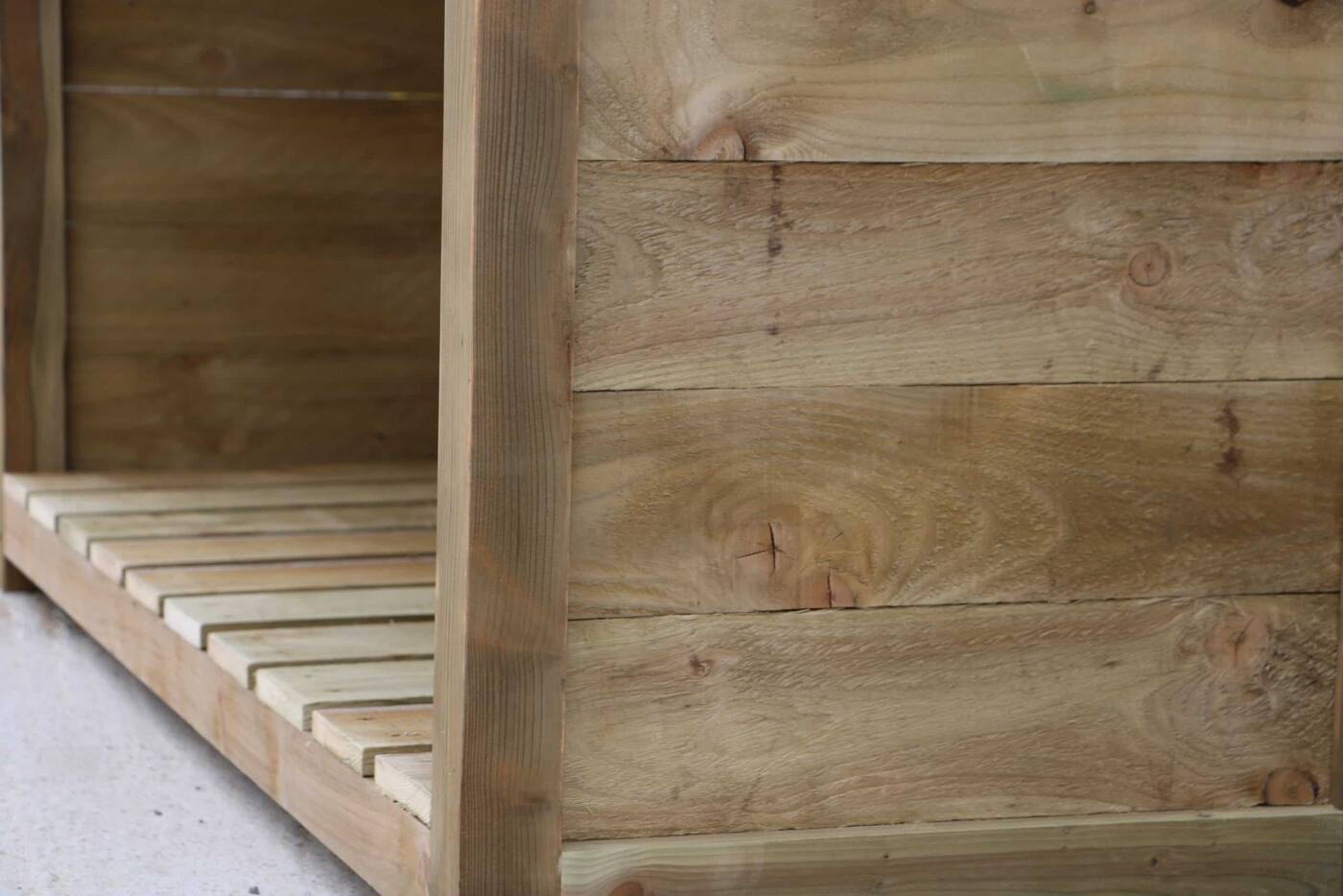 Wooden Log Store With Roof And Raised Floor